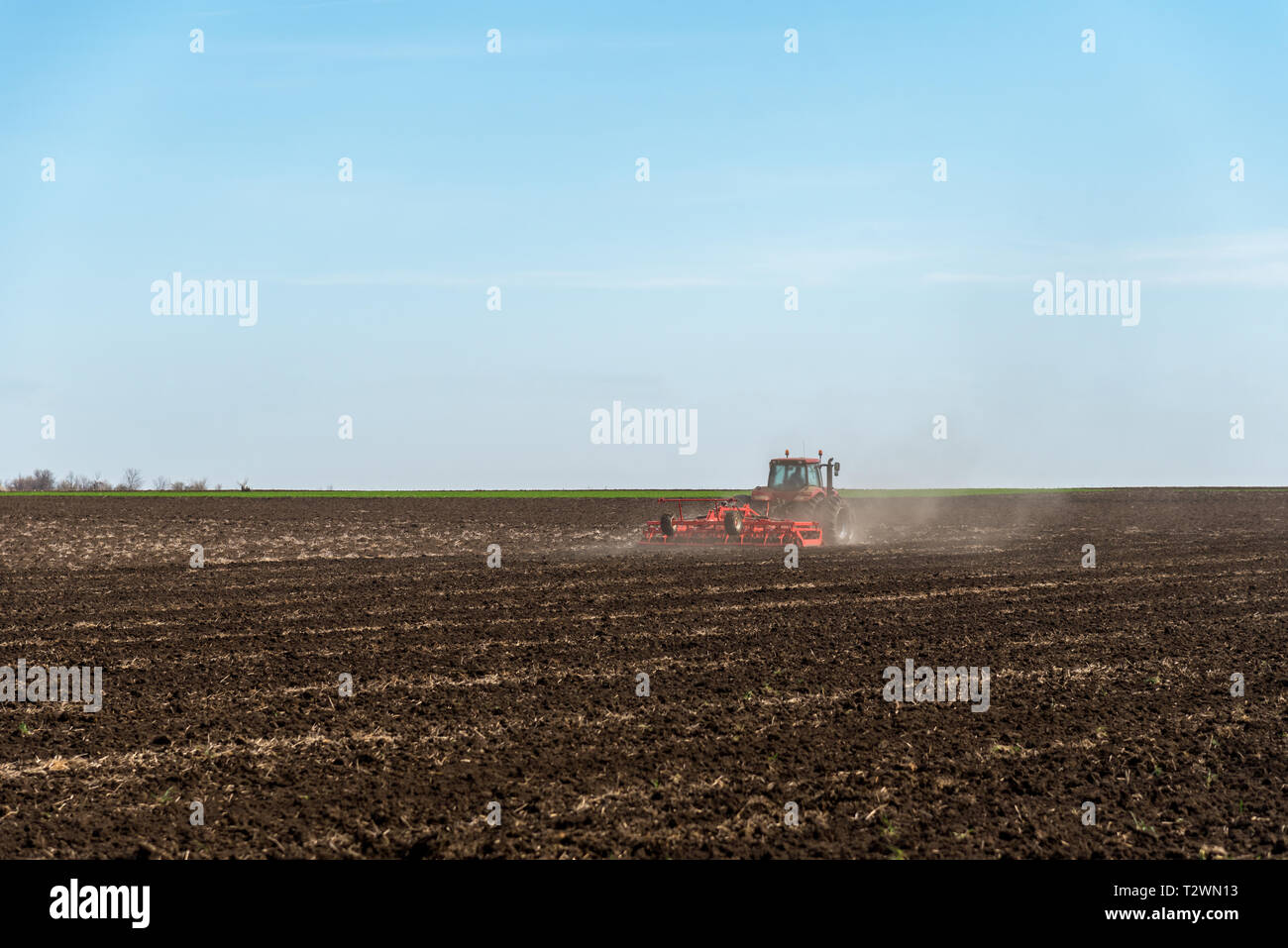 Tractor plowing fields. Preparing land for sowing in autumn Stock Photo ...