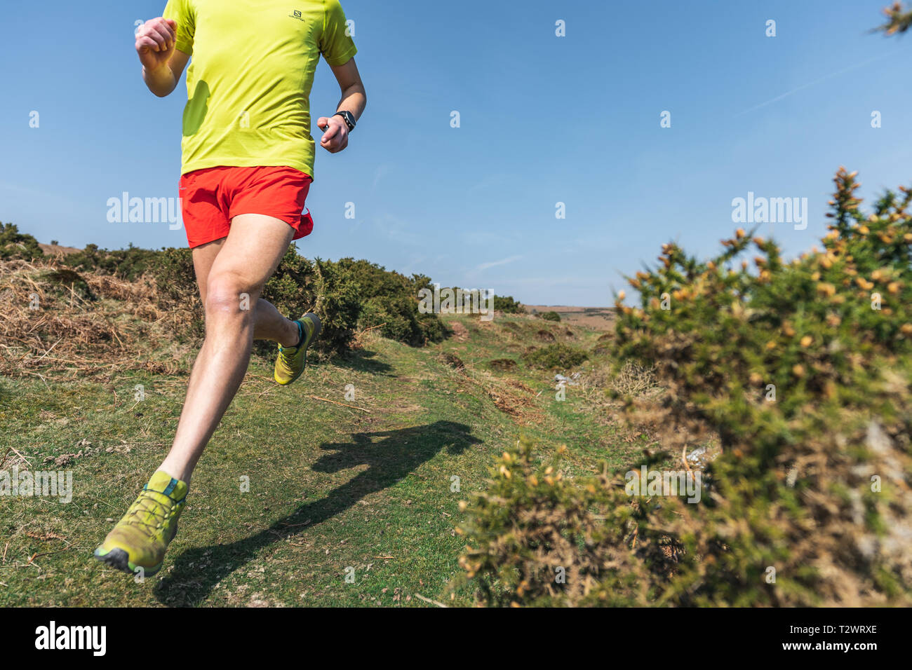 Man trail running on a mountain during a sunny day Stock Photo - Alamy