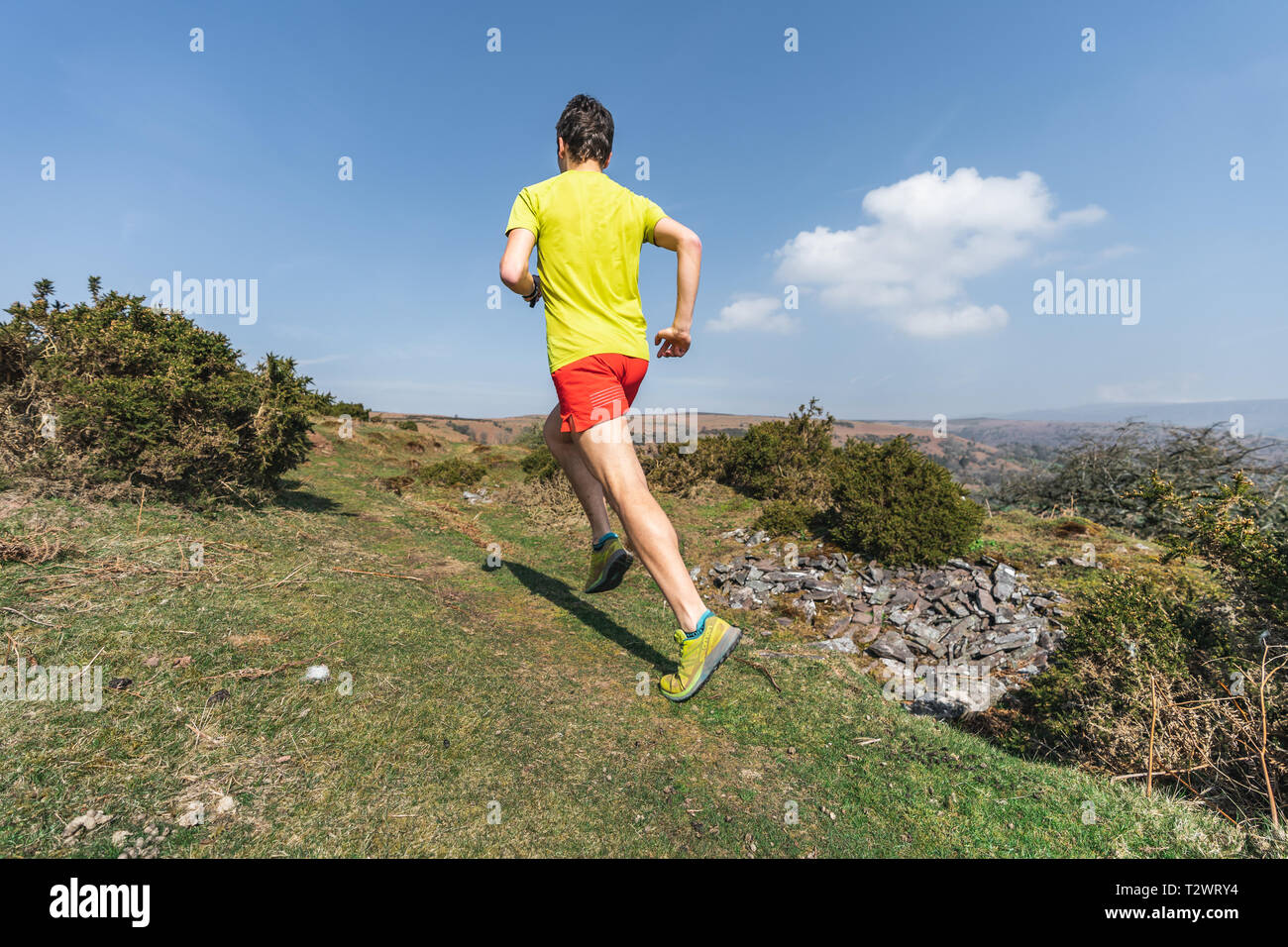 Man trail running on a mountain during a sunny day Stock Photo - Alamy