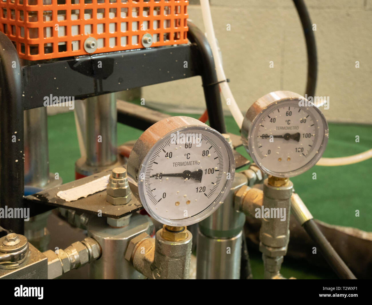closeup of two analog indicators of temperature with arrows showing ...