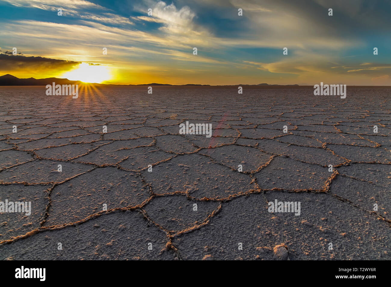 Golden sunset at Salar de Uyuni and Tunupa volcan in the background ...