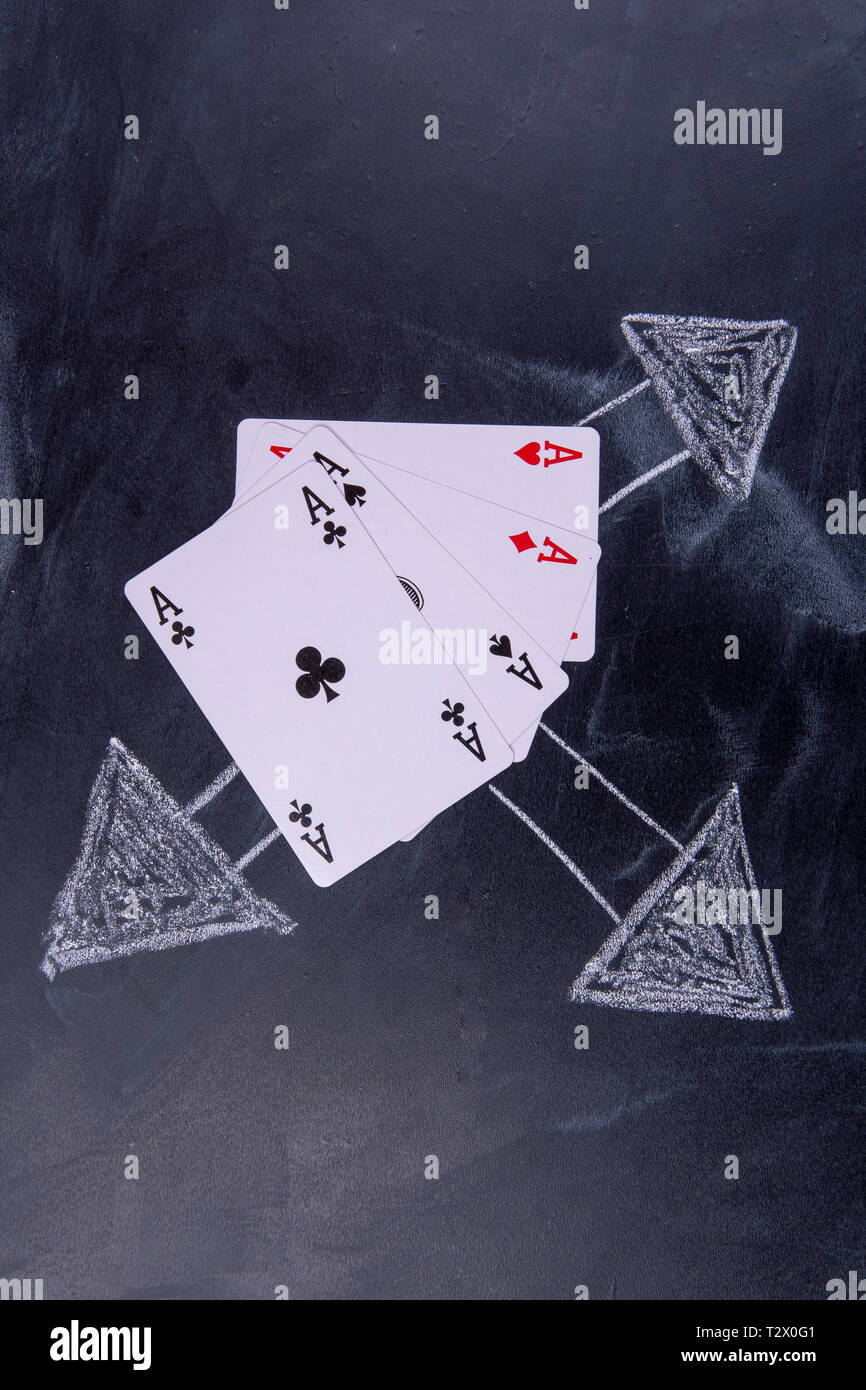 Playing cards with four aces and direction arrows Stock Photo - Alamy