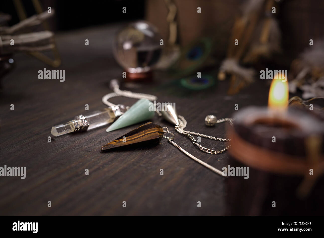 Magic and spells using a pendulum of natural stones Stock Photo - Alamy
