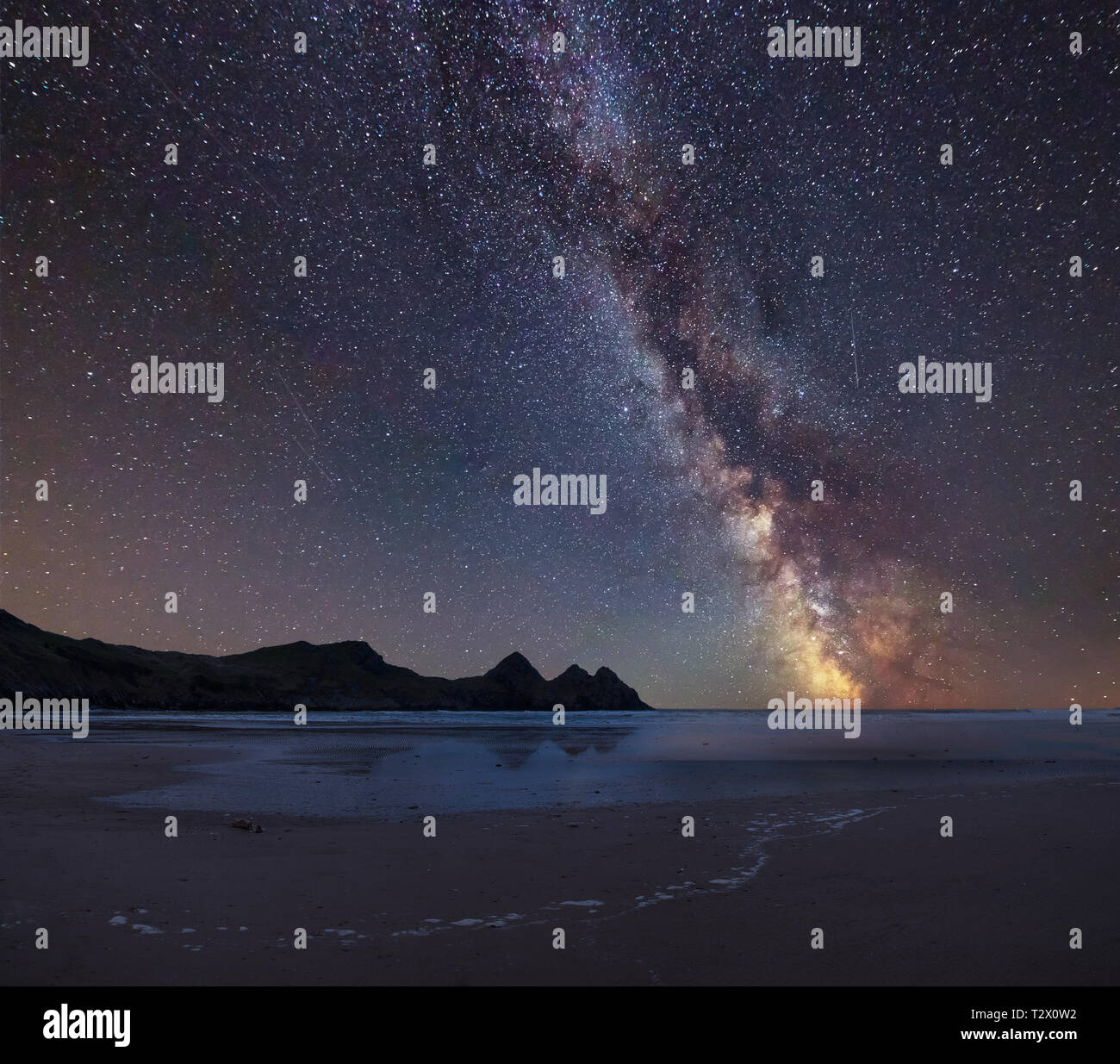 Stunning vibrant Milky Way composite image over landscape of yellow ...