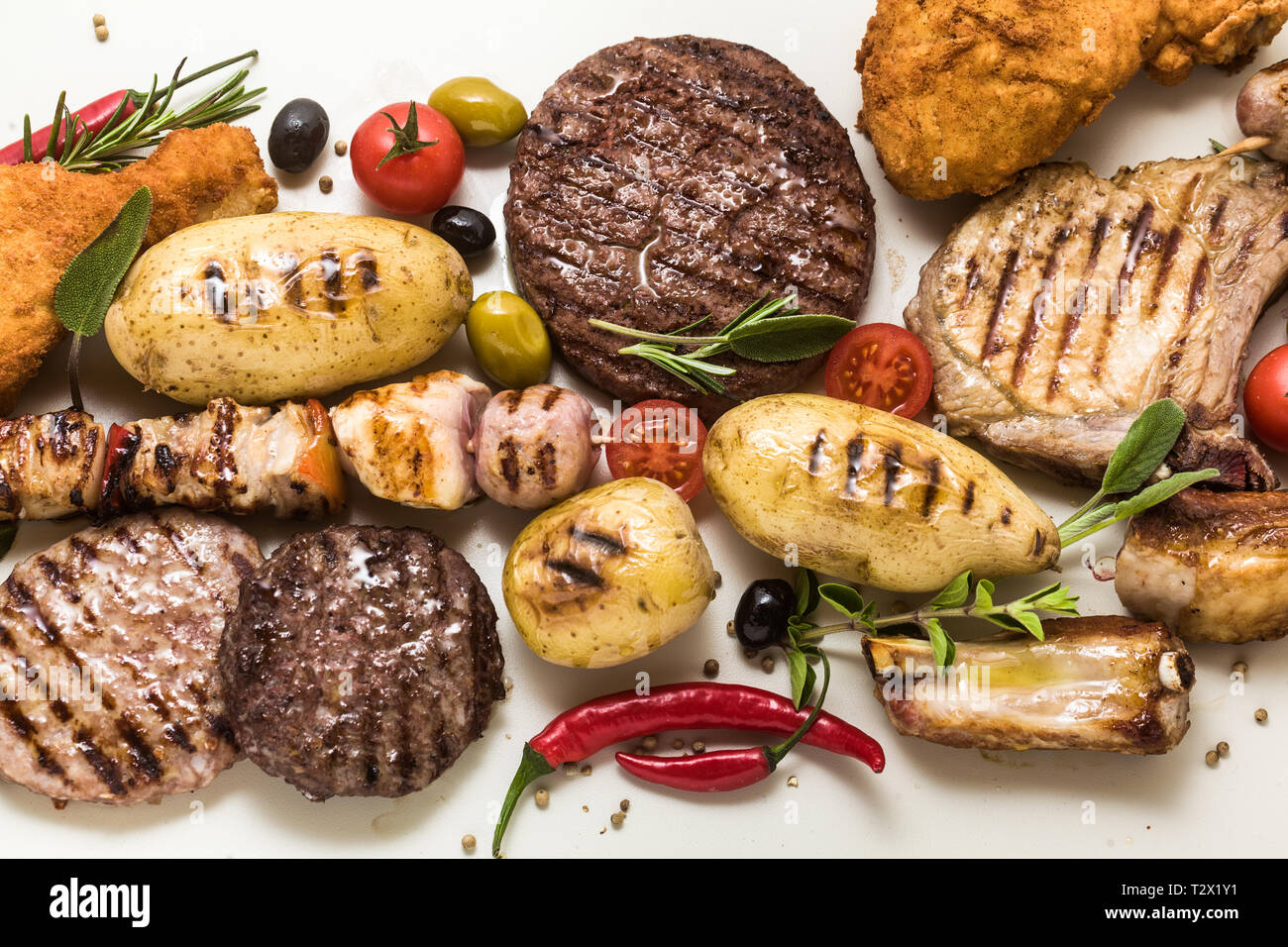 BBQ meat party with different types of meat: beef burgers, pork ribs ...