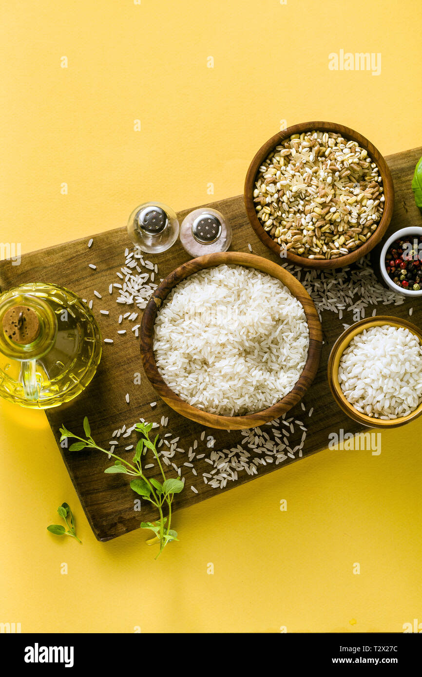 Different types of rice on a wooden board made from olive wood. Food ...