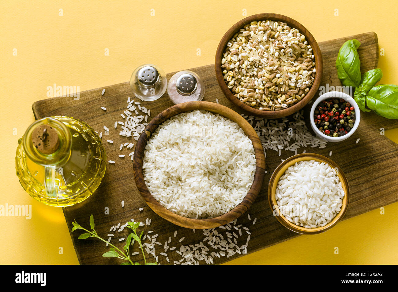 Different types of rice on a wooden board made from olive wood. Food ...