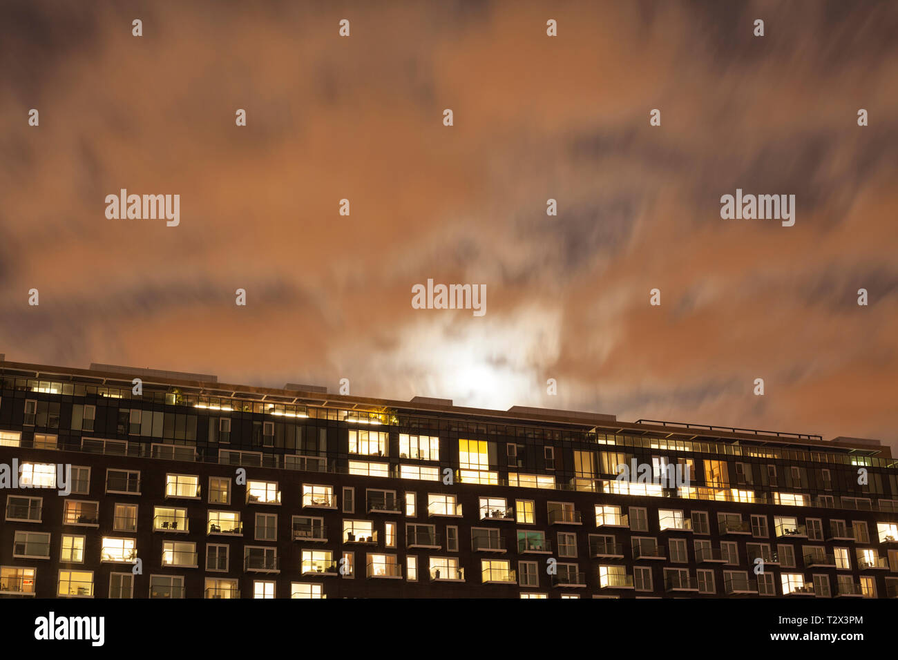 Modern apartment block at night Stock Photo - Alamy