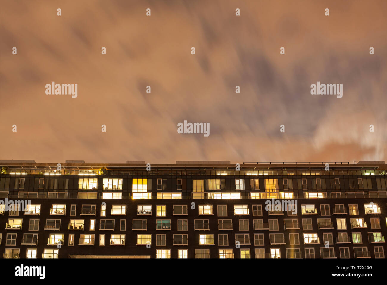 Modern apartment block at night Stock Photo - Alamy