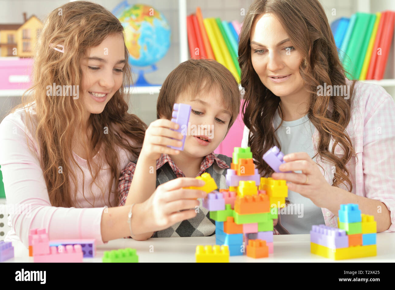 Happy family of three playing games at home Stock Photo - Alamy