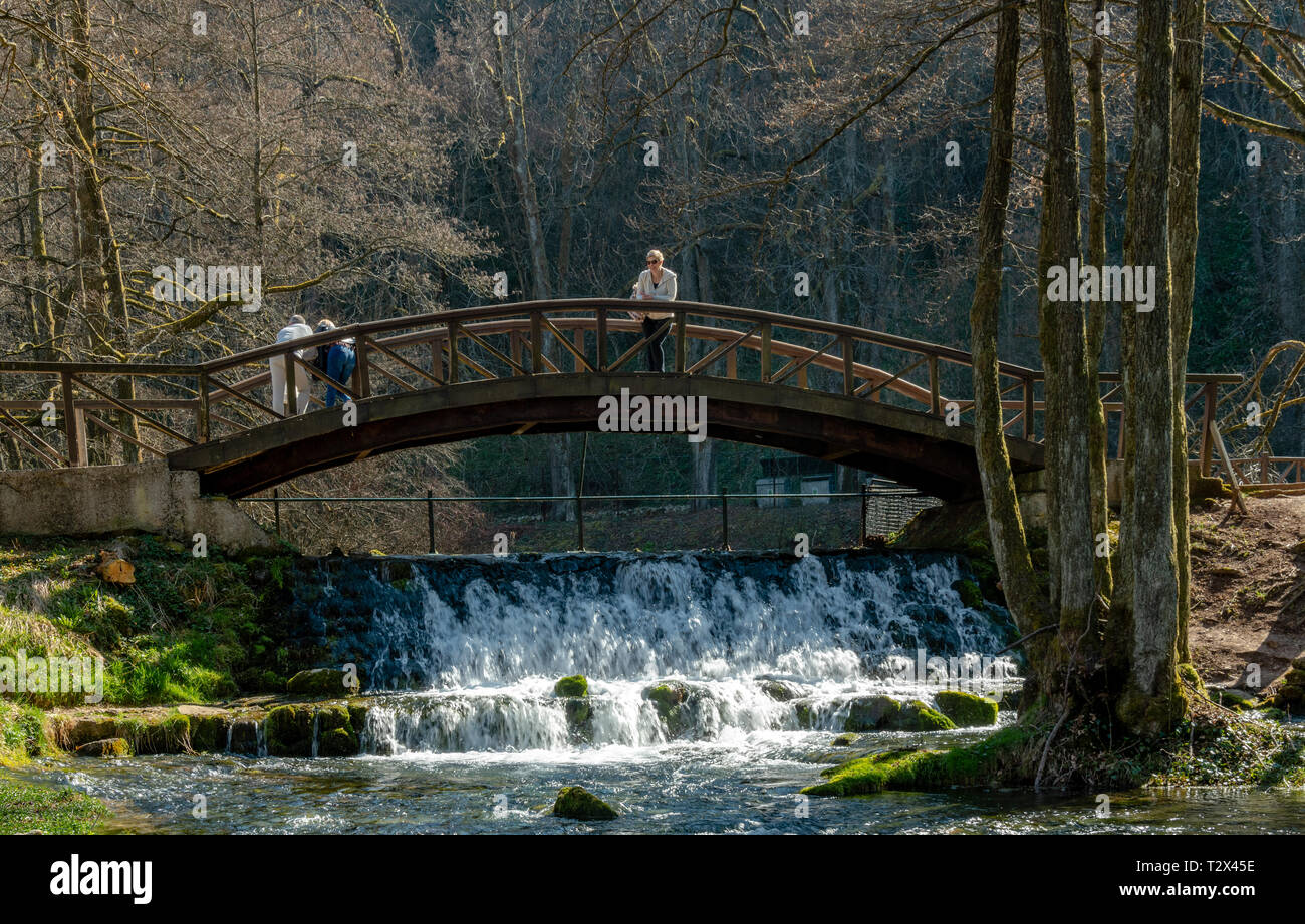 Wooden bridge over river's waterfall Stock Photo - Alamy