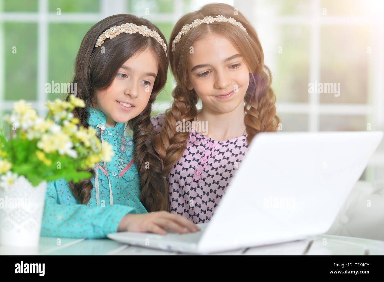 Two girls using laptop together hi-res stock photography and images - Alamy