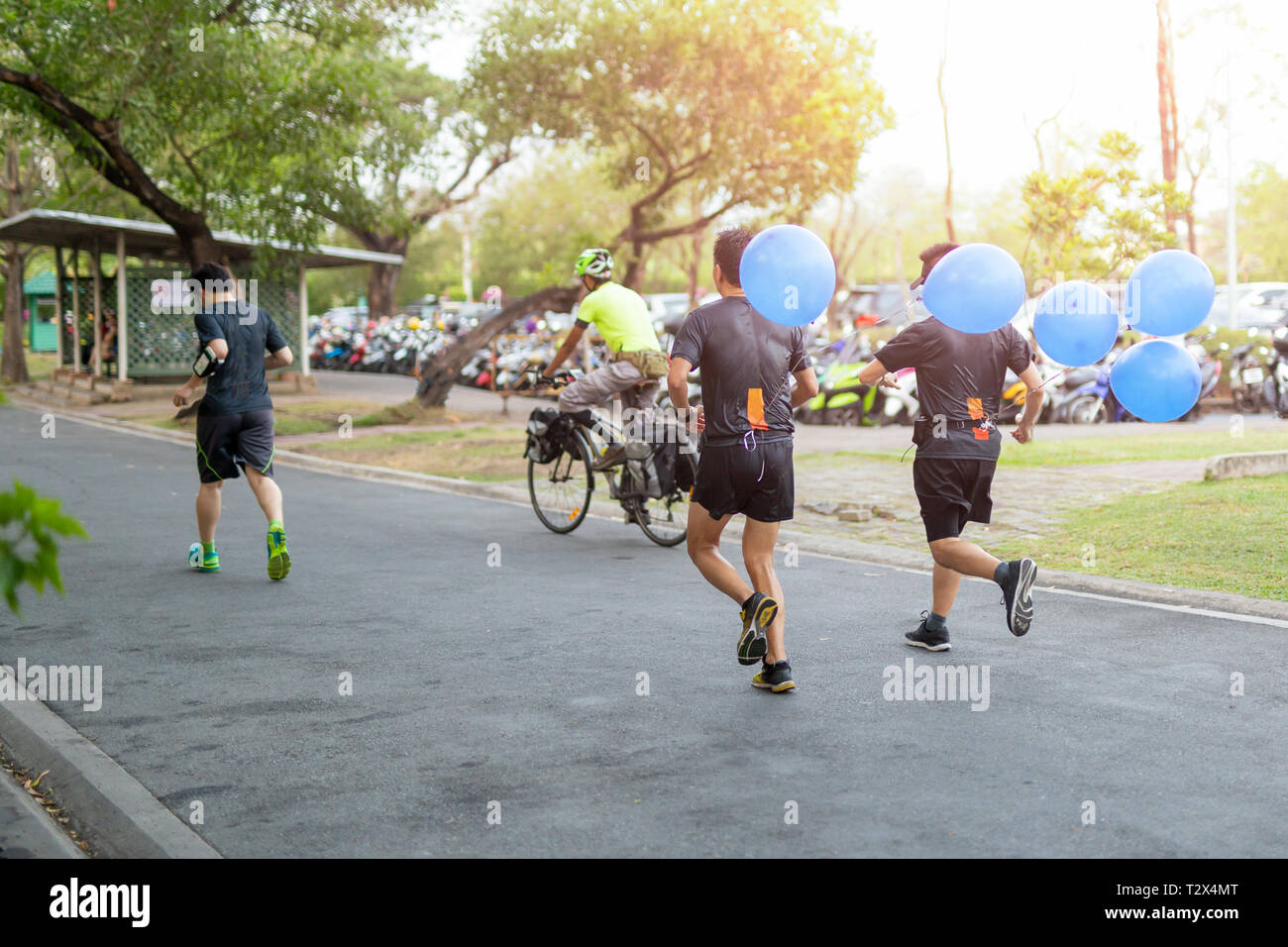 Marathon running in the park with blue balloon in summer Stock Photo ...