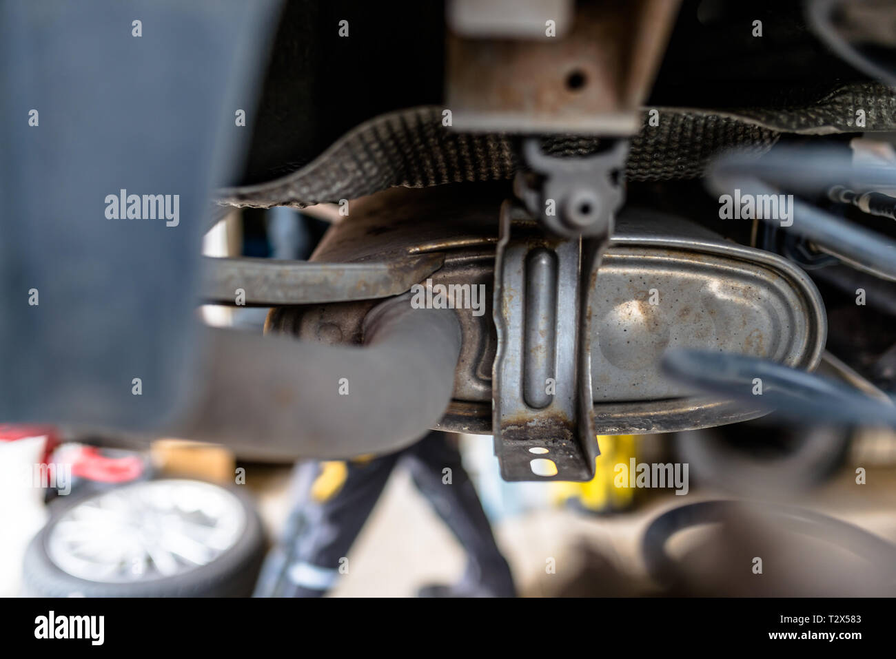 The exhaust system in the car seen from below, the car is on the lift ...