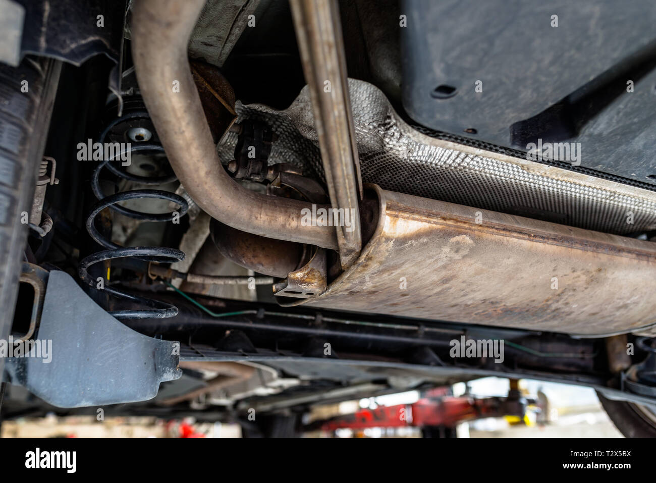 The exhaust system in the car seen from below, the car is on the lift ...