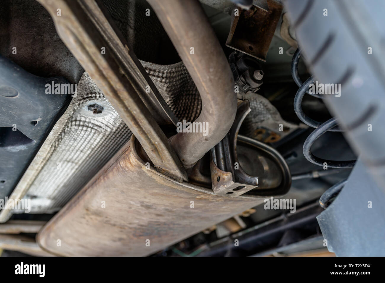 The exhaust system in the car seen from below, the car is on the lift ...