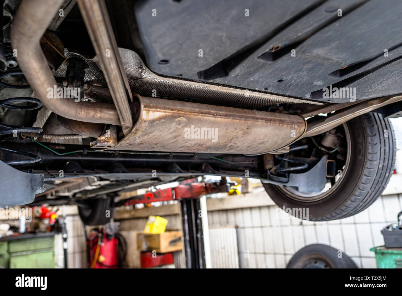 The exhaust system in the car seen from below, the car is on the lift ...
