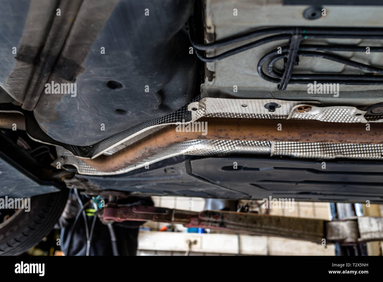 The exhaust system in the car seen from below, the car is on the lift ...
