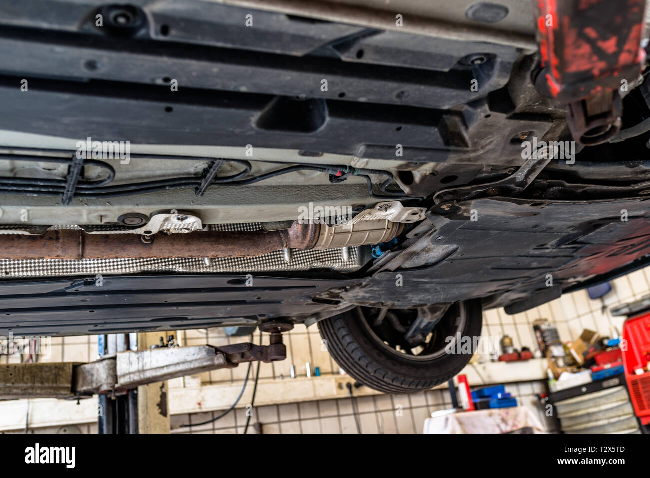 The exhaust system in the car seen from below, the car is on the lift ...