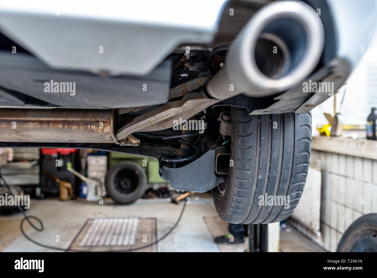 The exhaust system in the car seen from below, the car is on the lift ...