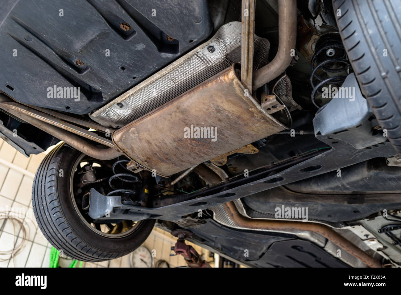 The exhaust system in the car seen from below, the car is on the lift ...