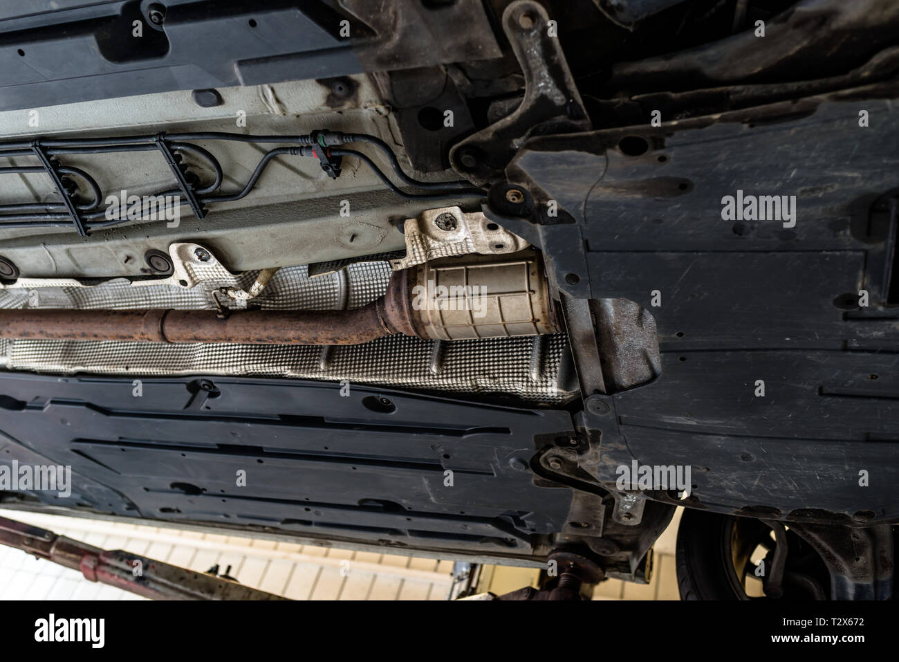 The exhaust system in the car seen from below, the car is on the lift ...