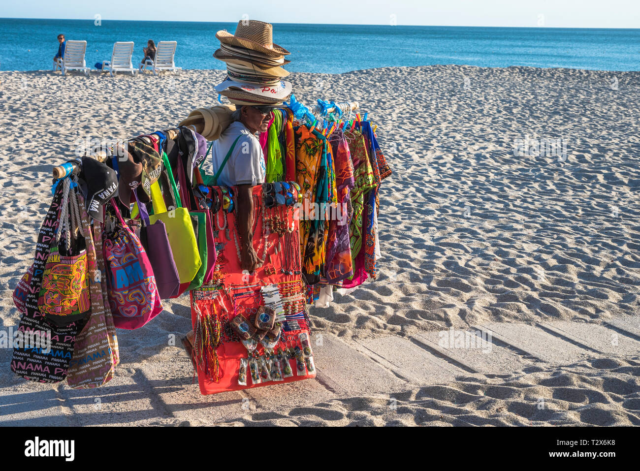 Beach scenes with souvenir beach article vendor Stock Photo - Alamy