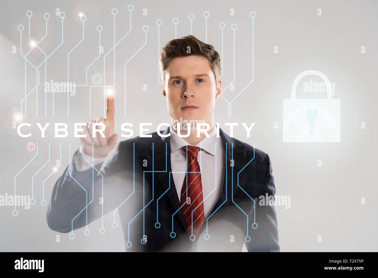 confident businessman in suit pointing with finger at cyber security illustration in front Stock ...