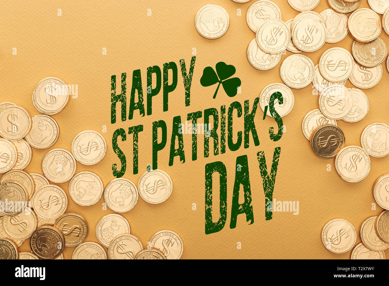 top view of golden coins near happy st patricks day lettering on orange ...