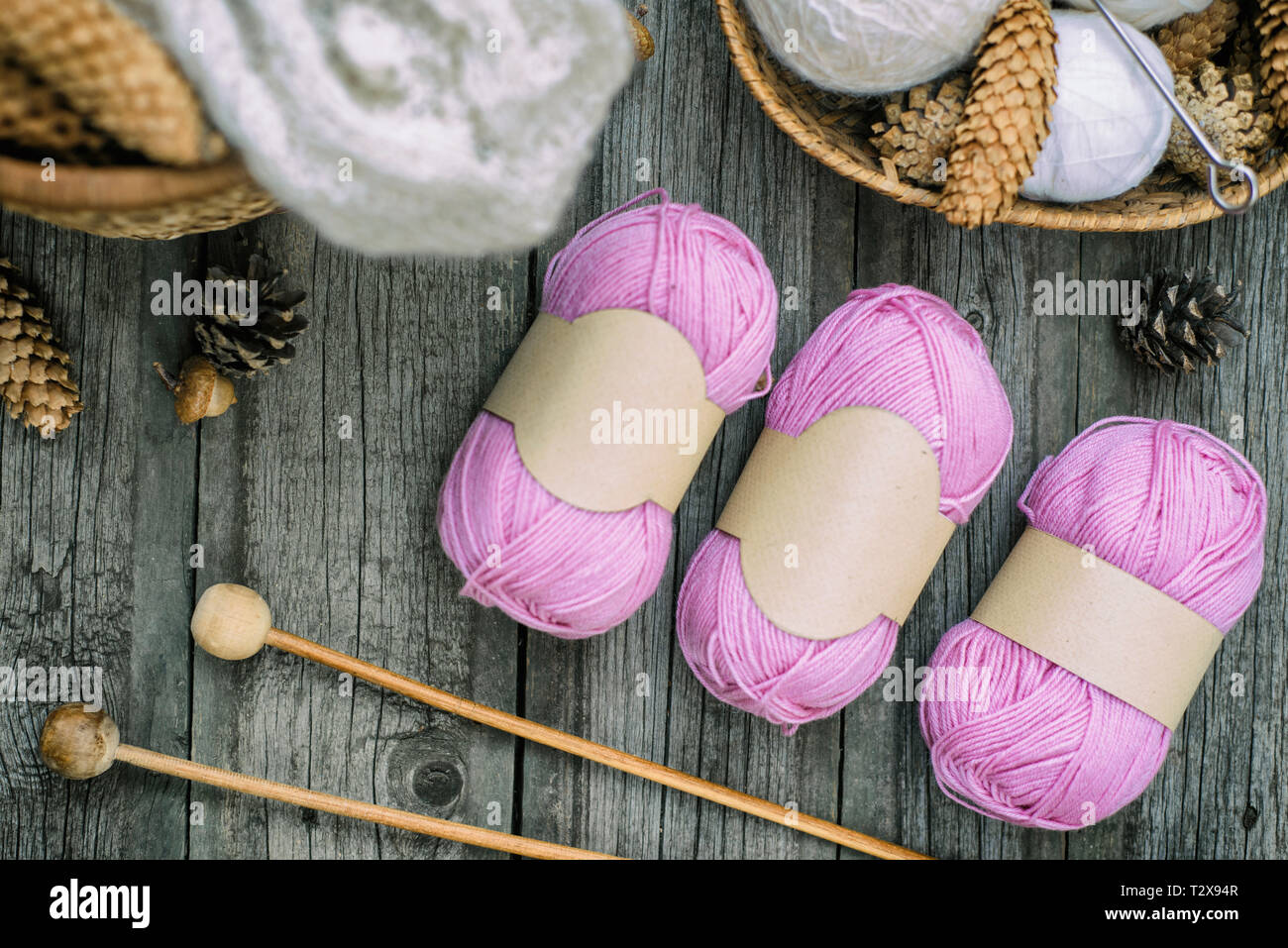 Three pink balls of wool threads with empty labels lying on vintage ...
