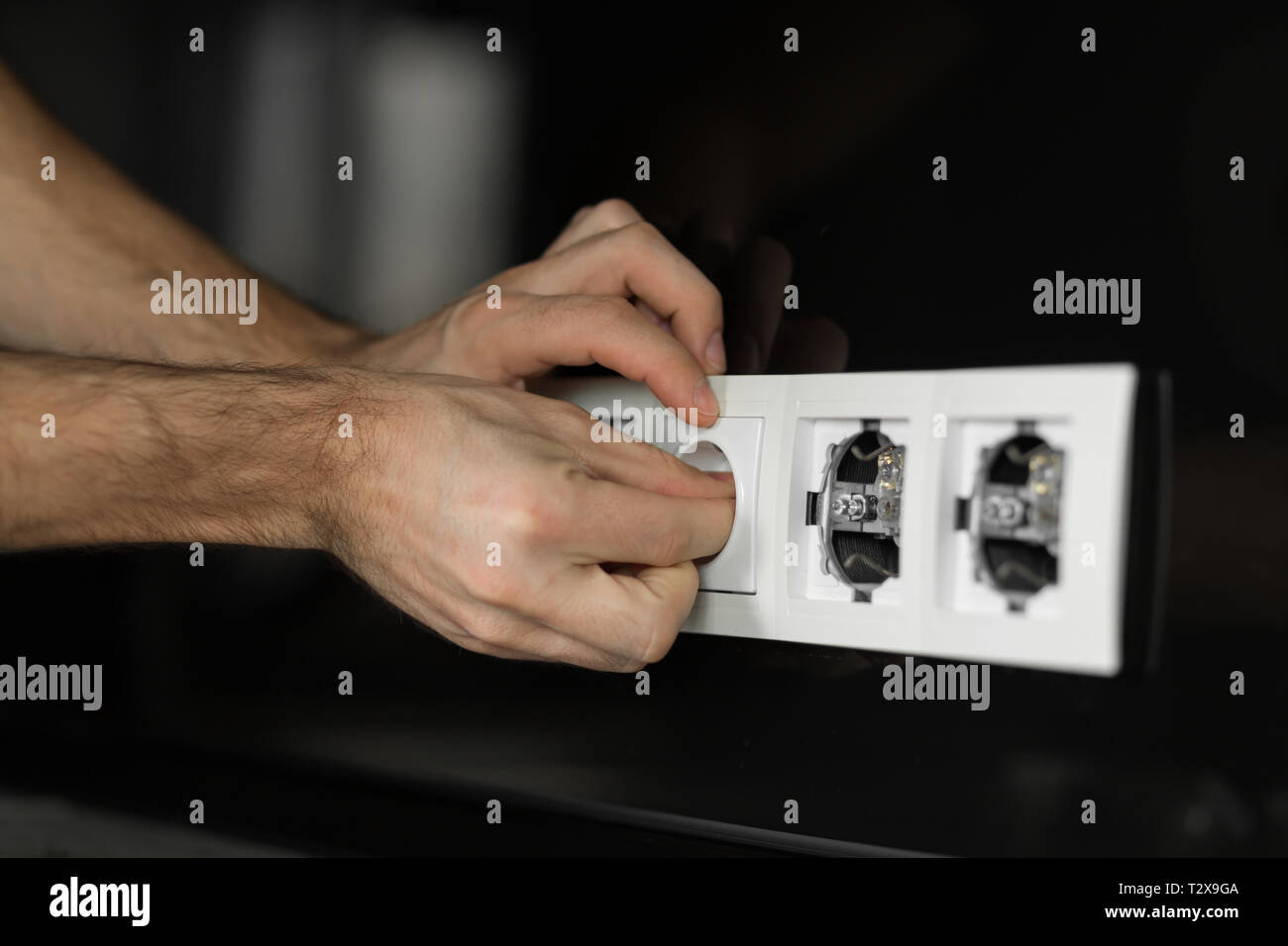 Close-up of an electrician's hand without any tools and gloves ...