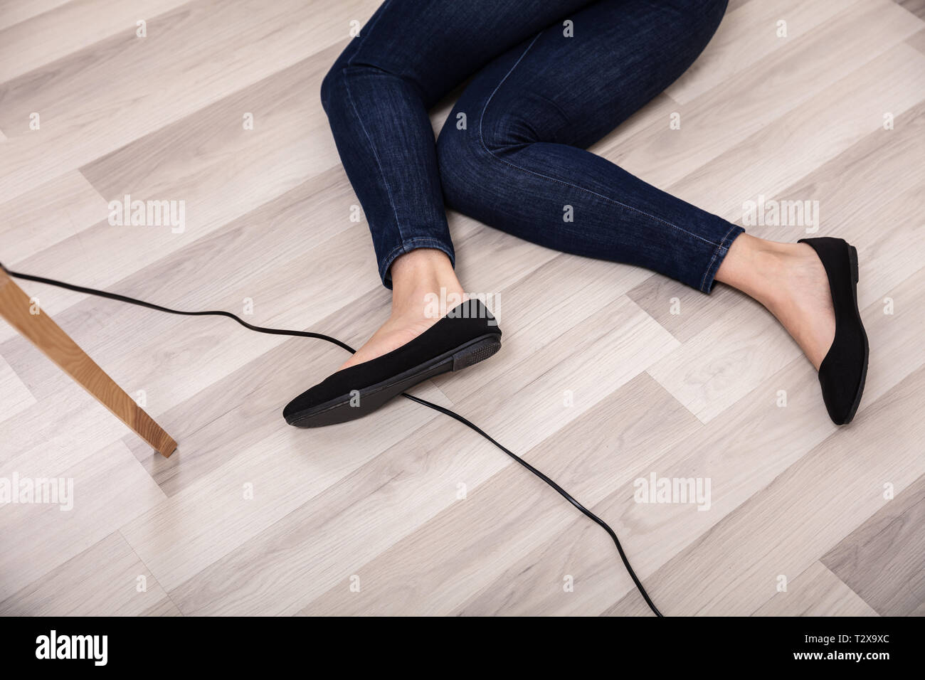 An Elevated View Of Woman Stumbling With An Electrical Cord Stock Photo ...