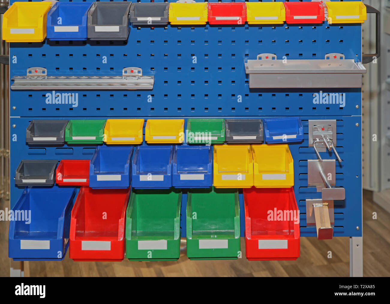 Colorful plastic bins and trays in storage room Stock Photo - Alamy