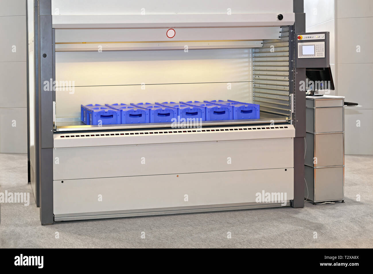 Automated vertical tower storage carousel in warehouse Stock Photo - Alamy