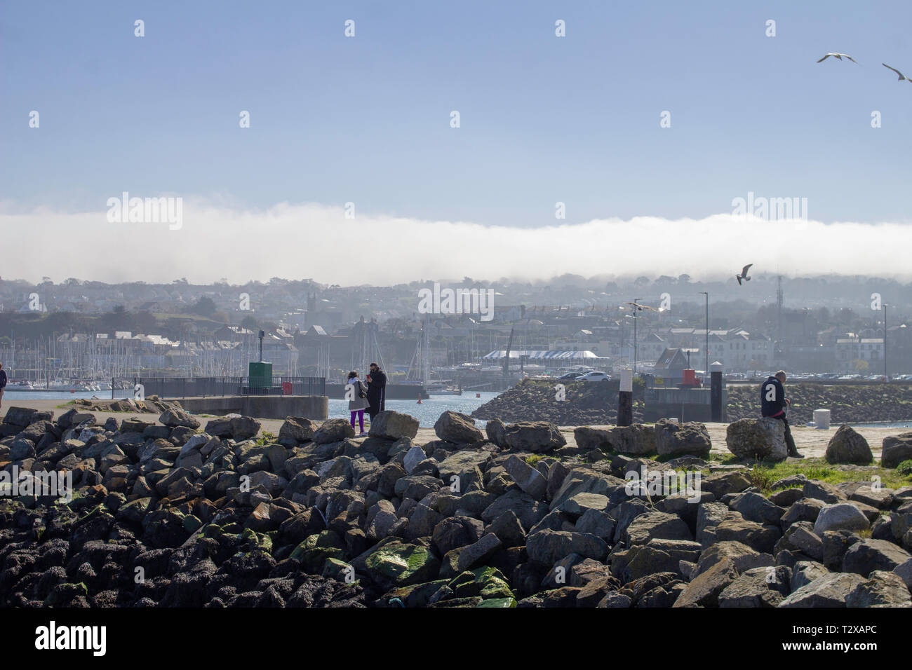 The West Pier in Howth Harbour, Dublin, Ireland and in the background ...