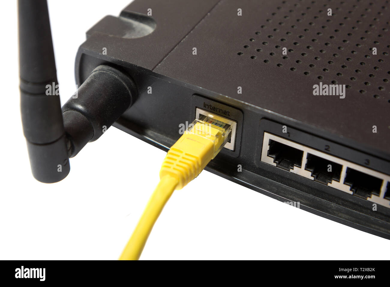 wireless router with yellow internet cable on white background Stock ...