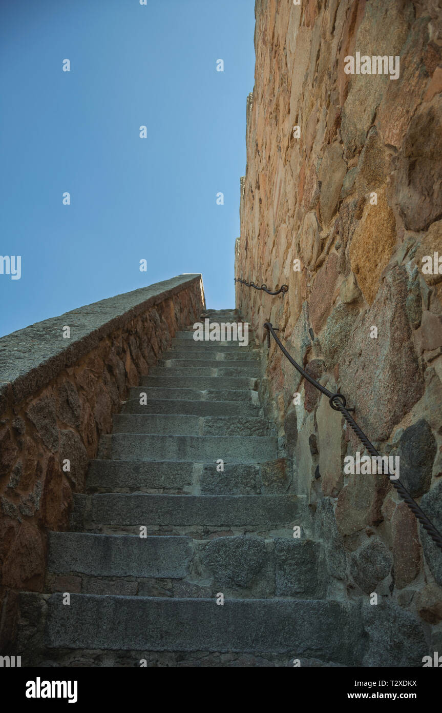 Staircase made of stone bricks going up towards a thick wall around the ...