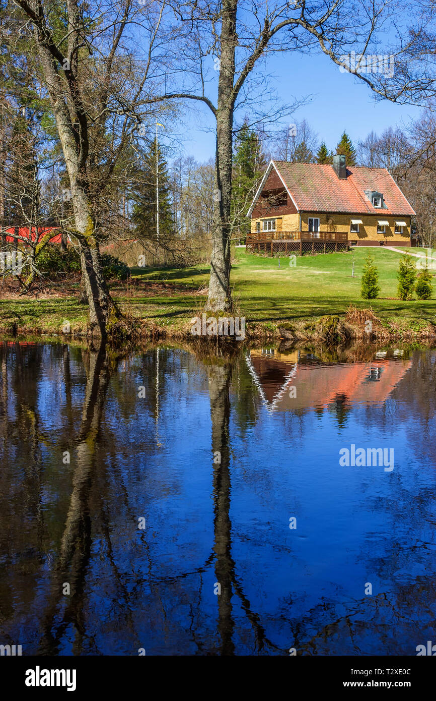 House with garden by a river Stock Photo - Alamy