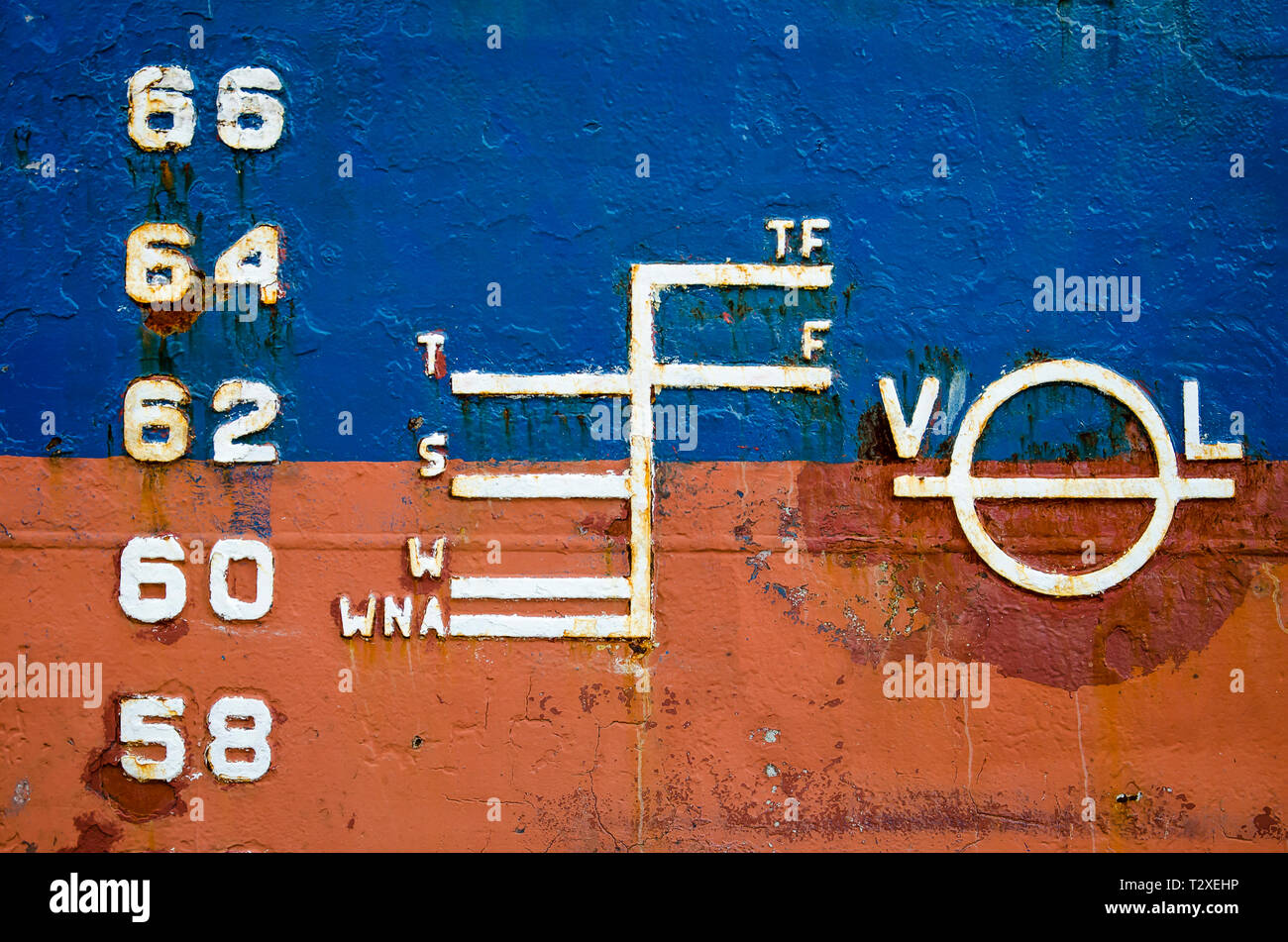 Detail of a ship's hull, painted blue and red, with draught marks as ...