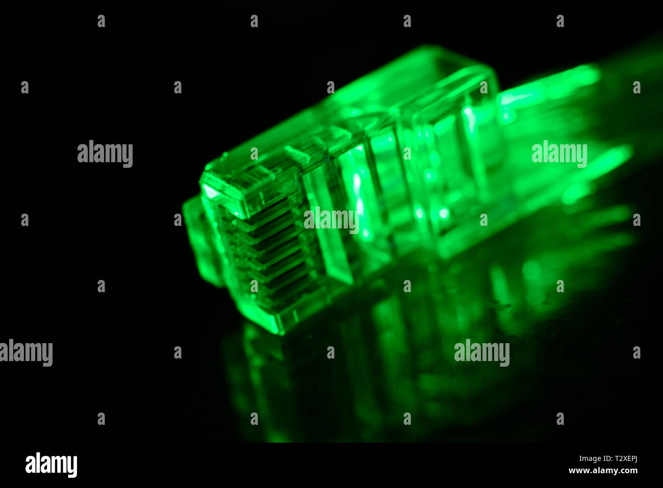 Network connection plug with fiber optics cable isolated on black ...