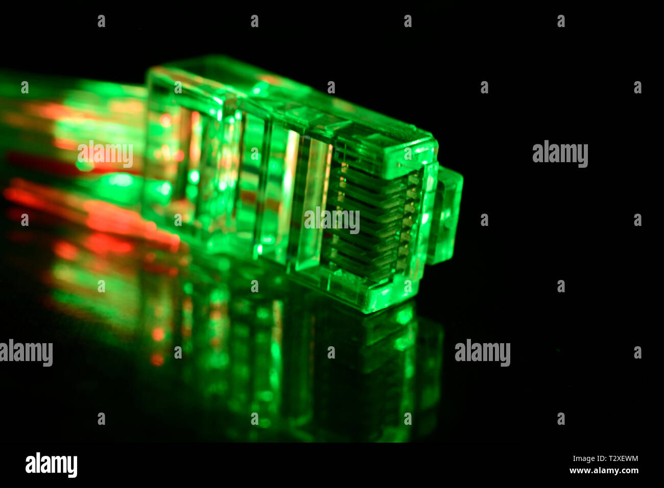 Network connection plug with fiber optics cable isolated on black ...