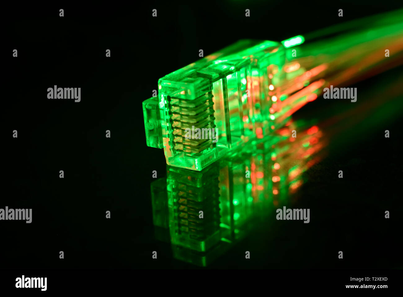 Network connection plug with fiber optics cable isolated on black ...