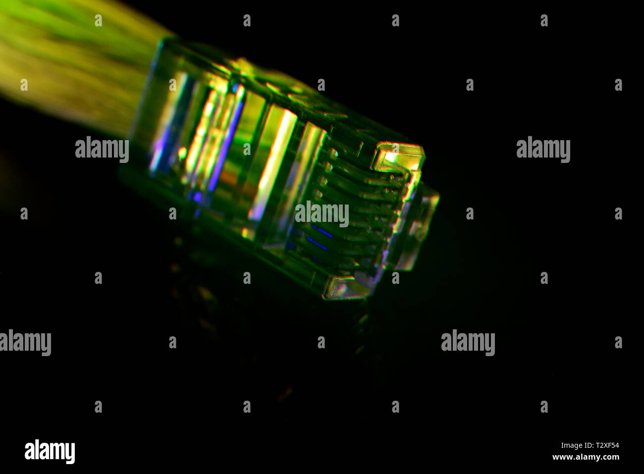 Network connection plug with fiber optics cable isolated on black ...