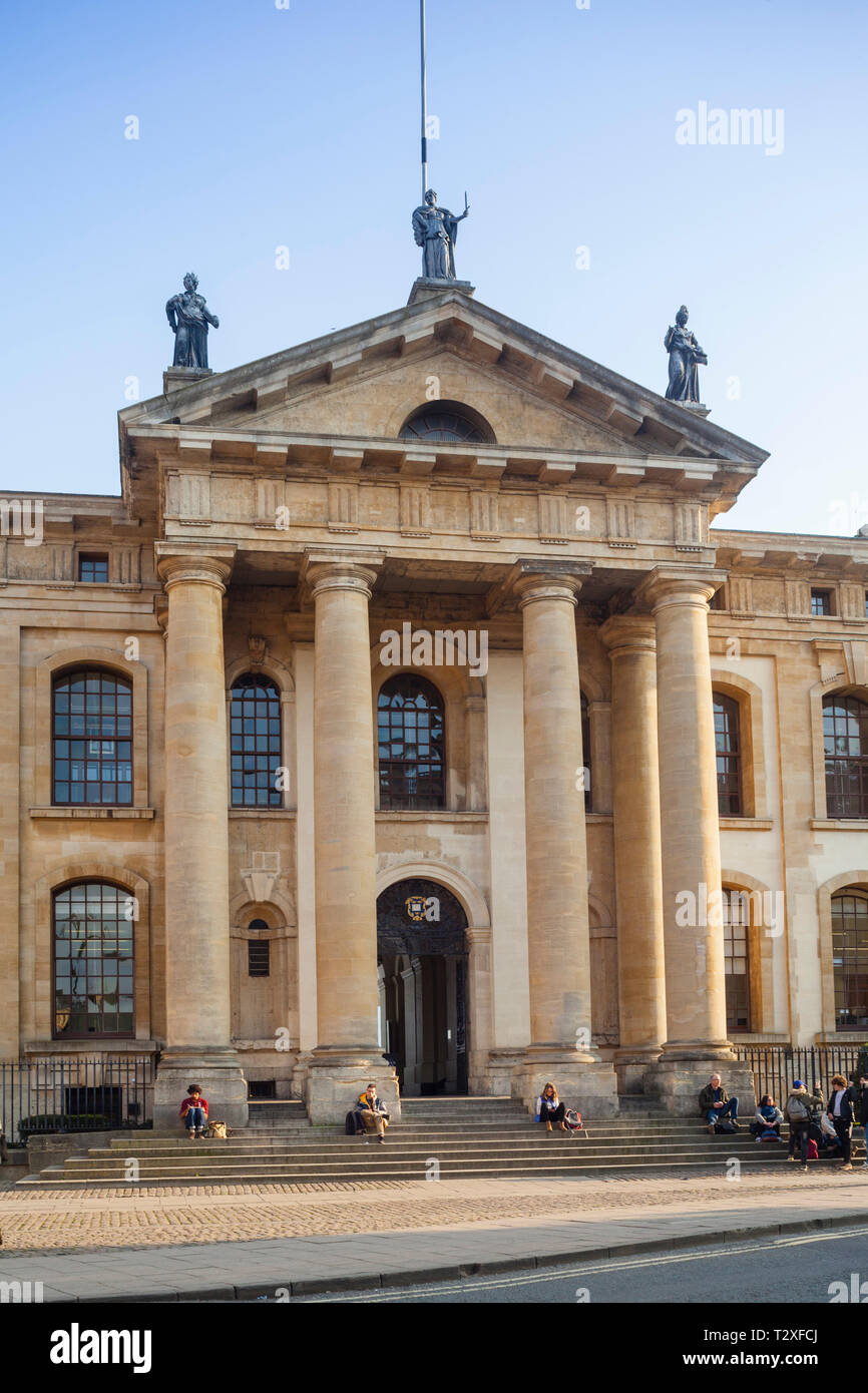 Tourists and students sit on the steps of the early 18th Century ...