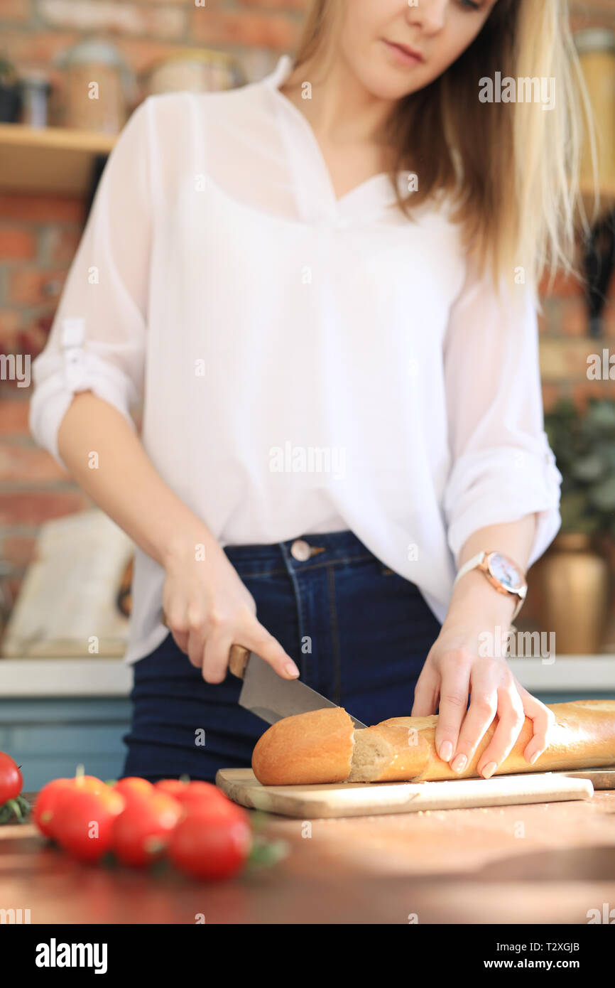Lovely girl is cooking at home Stock Photo - Alamy