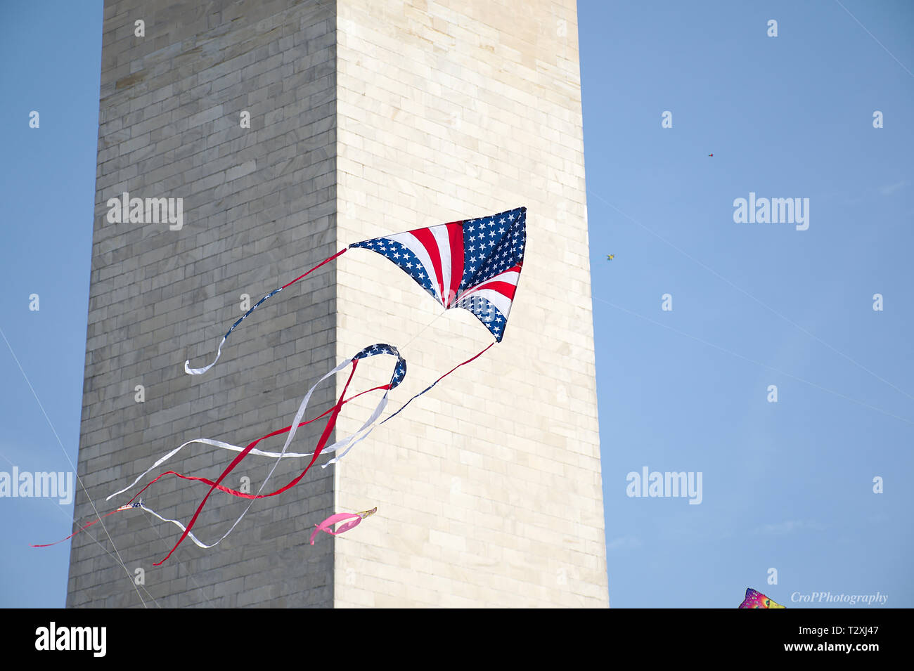 Closeup American Flag Kite flying with Washington Monument in ...