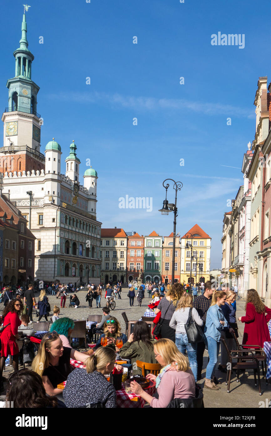 People men and women sitting outside eating and drinking at cafes in ...