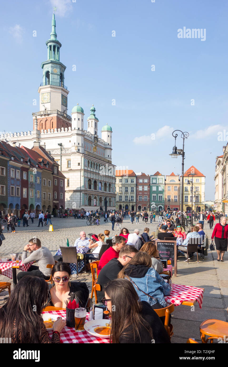 People men and women sitting outside eating and drinking at cafes in ...