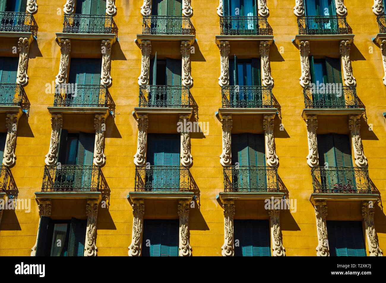 Old building with colorful facade and windows with iron balustrade in ...