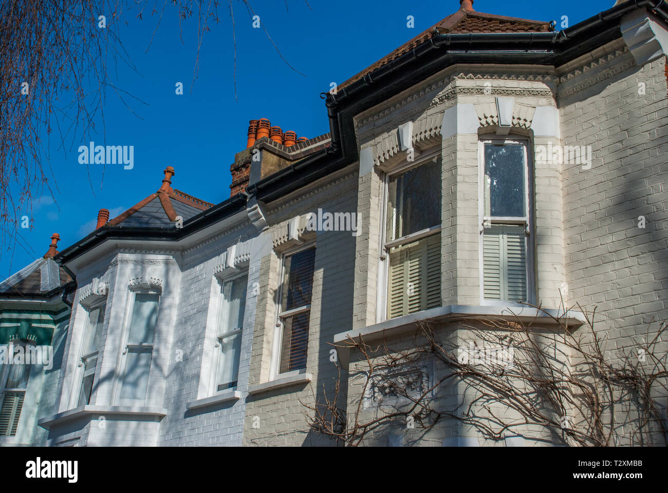 The afternoon sun shines through a beautiful white brick house in the ...